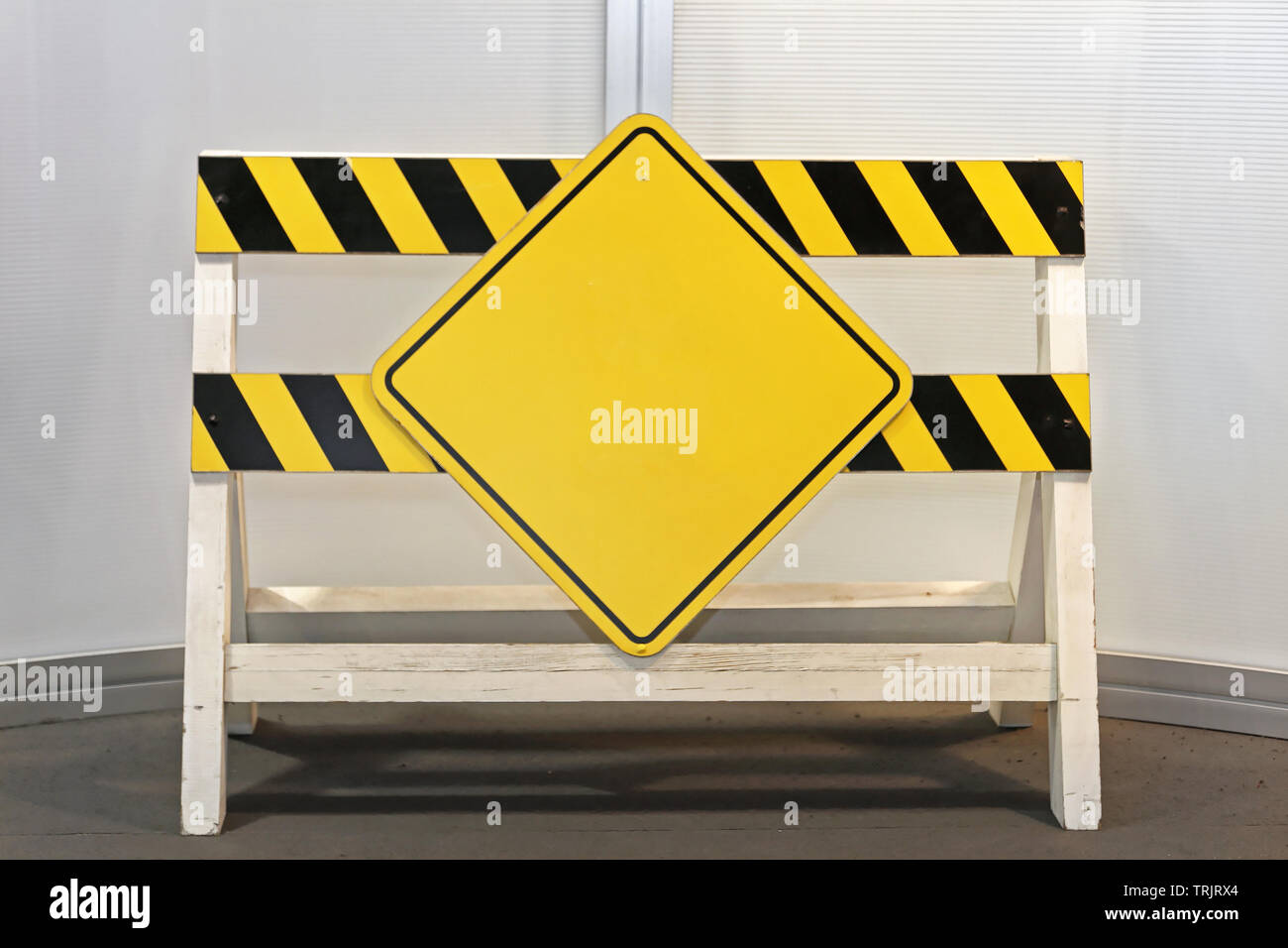 Construction Site Barrier With Yellow Warning Sign Stock Photo - Alamy