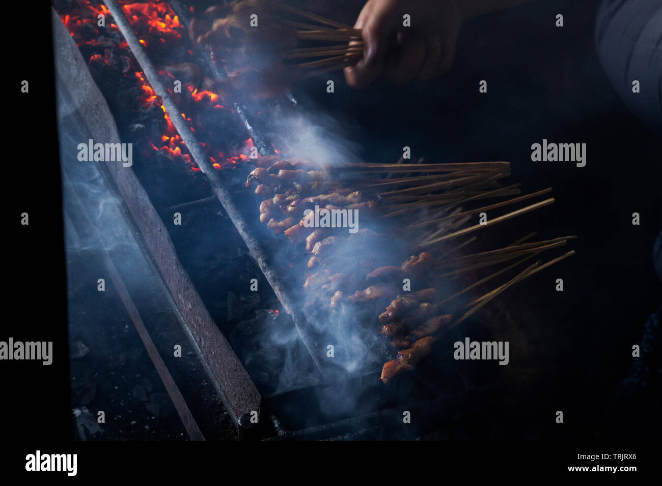 Chicken satay grill at a busy street food market Stock Photo - Alamy