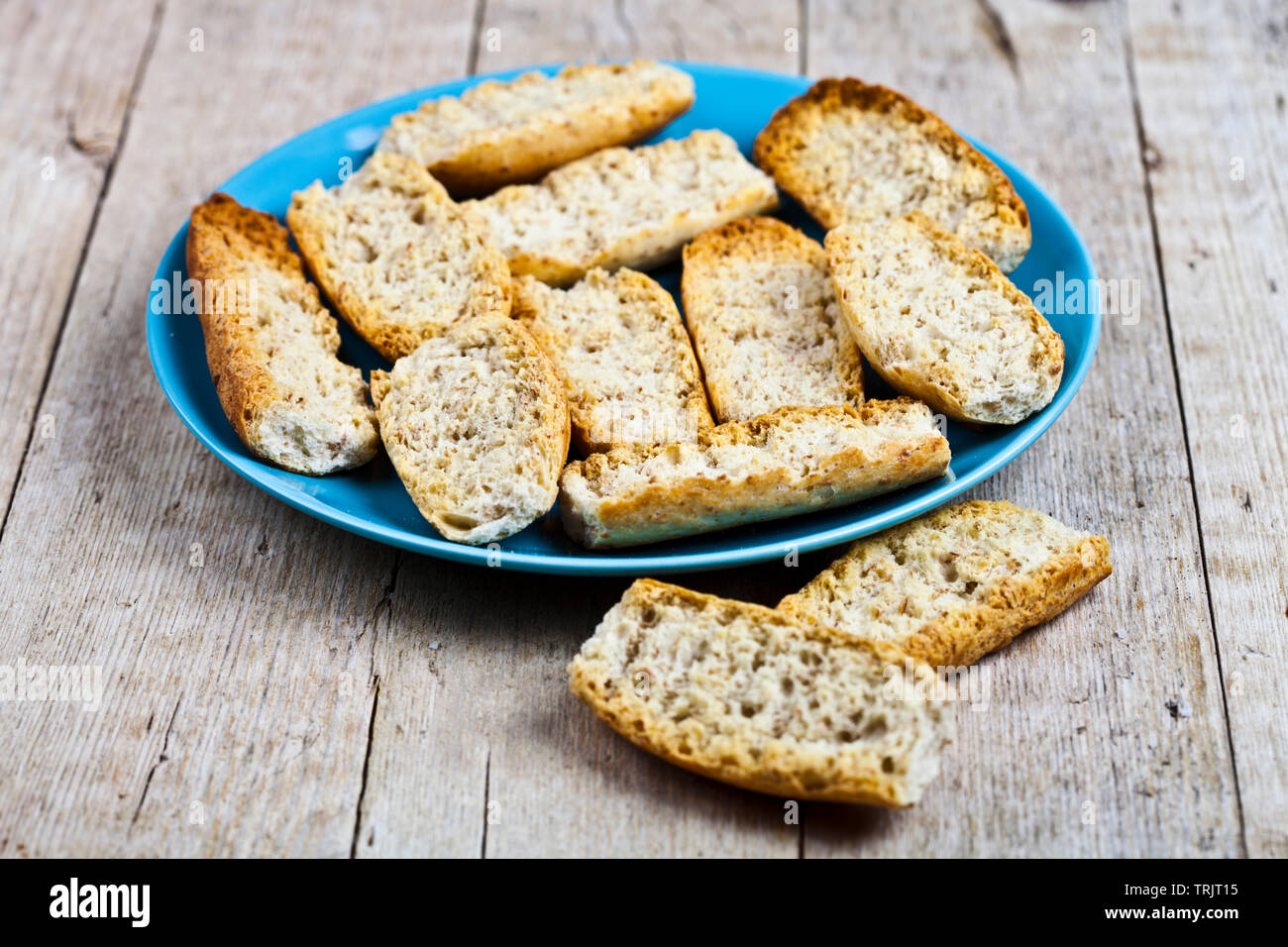 Fresh italian croutons crostini on blue plate on rustic wooden table ...
