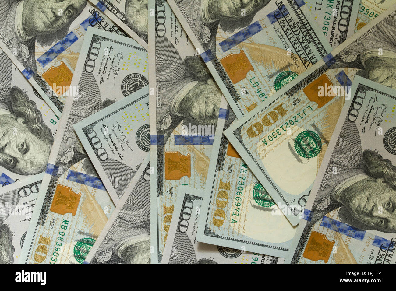 Background of 100 dollar bills. Pile of new design US dollar bills as ...
