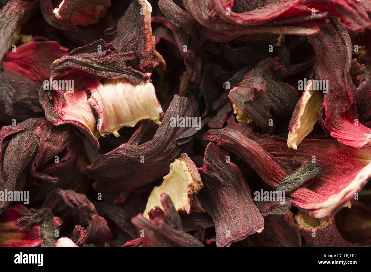 Dry carcade tea, creative texture background, red flowers of hibiscus ...