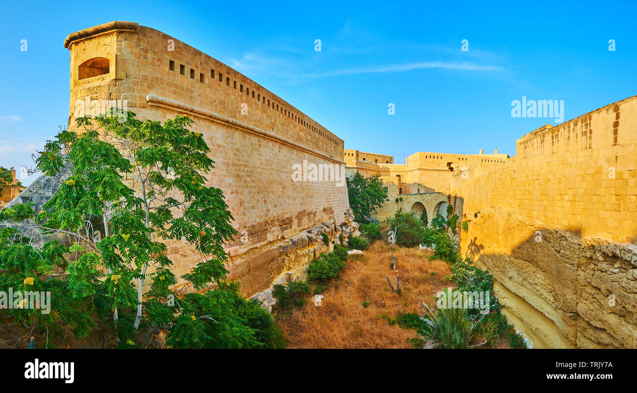 The deep moat in front of the bastions and ramparts of medieval Fort St ...