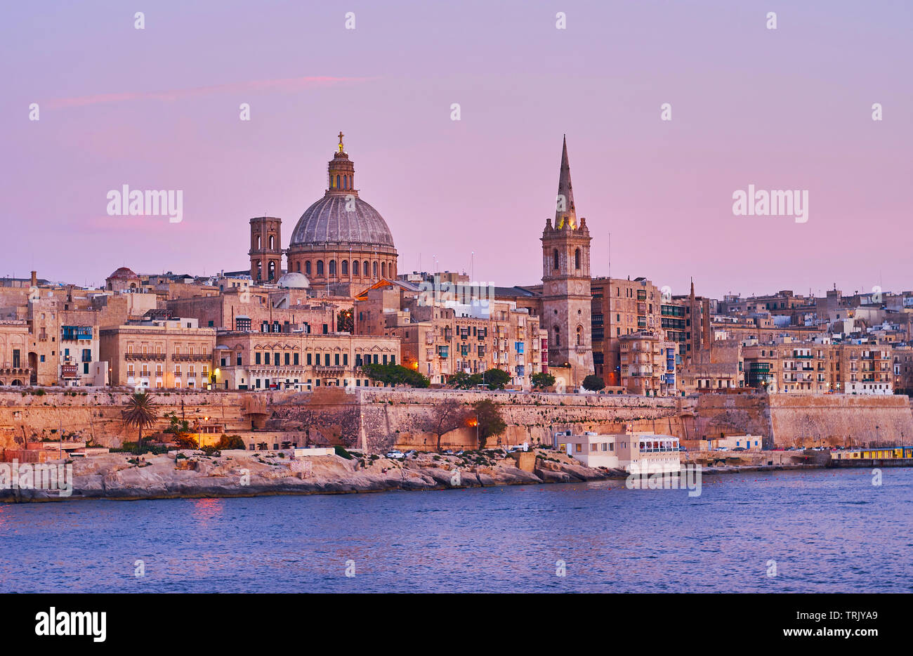 The medieval limestone city looks great in purple sunset colors, the ...