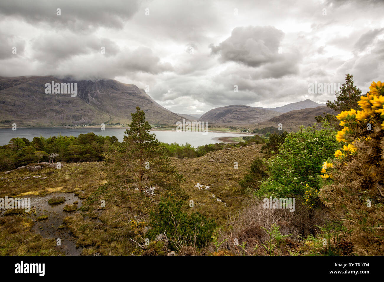 Misty landscape with clouds hanging over mountains that hem Loch ...