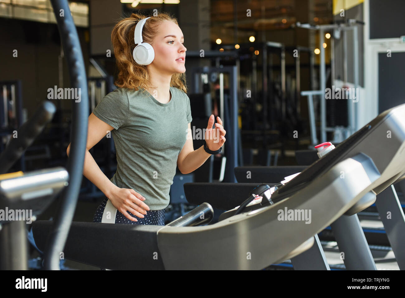 Young woman wearing headphones running hi-res stock photography and ...