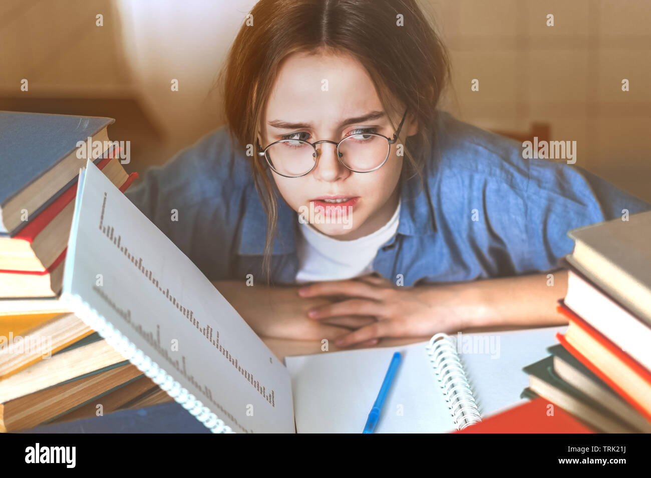 Stressed college student tired of hard learning with books in exams ...