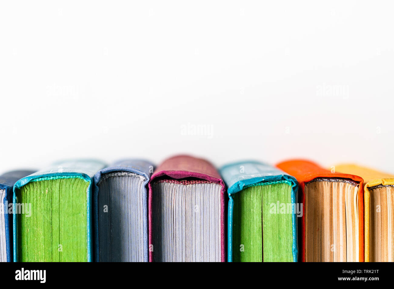 stack of old colorfull books on white background with copyspace, top ...