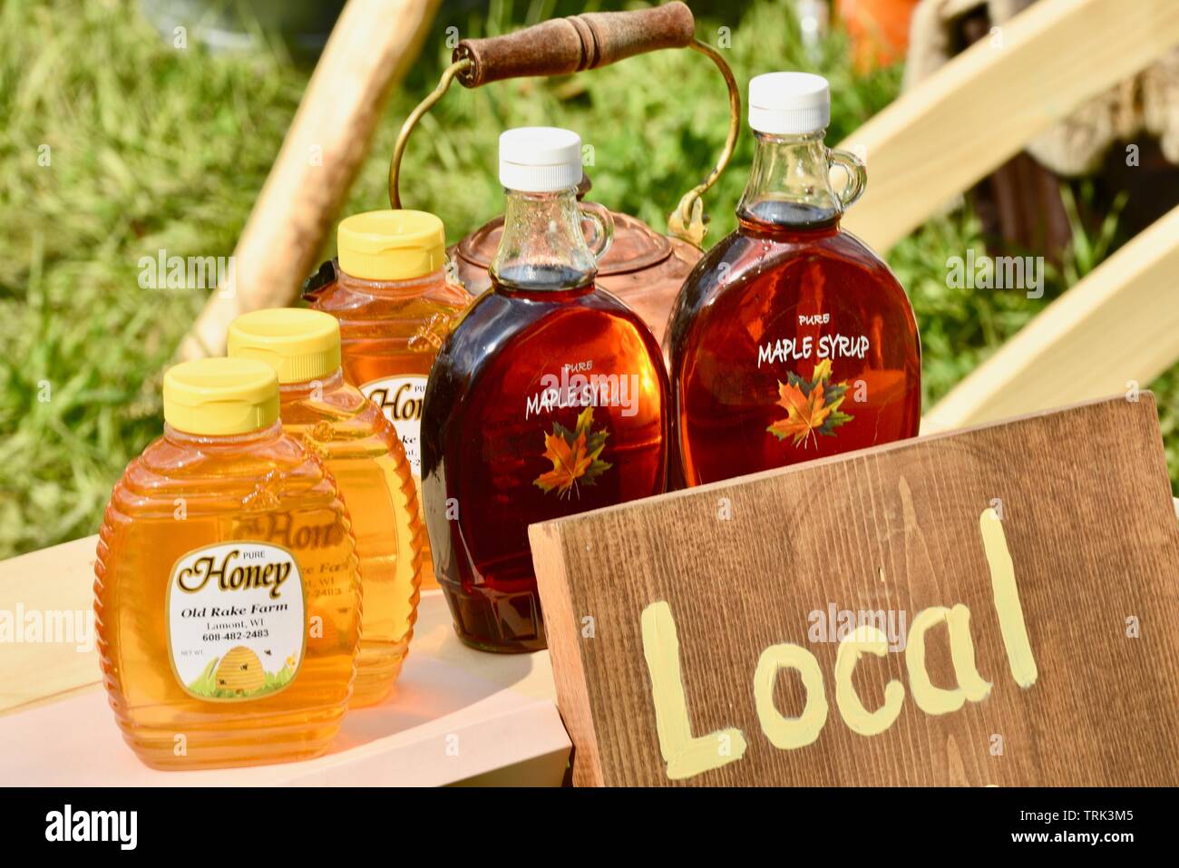 Sunlight shining through natural, local honey and maple syrup, for sale ...