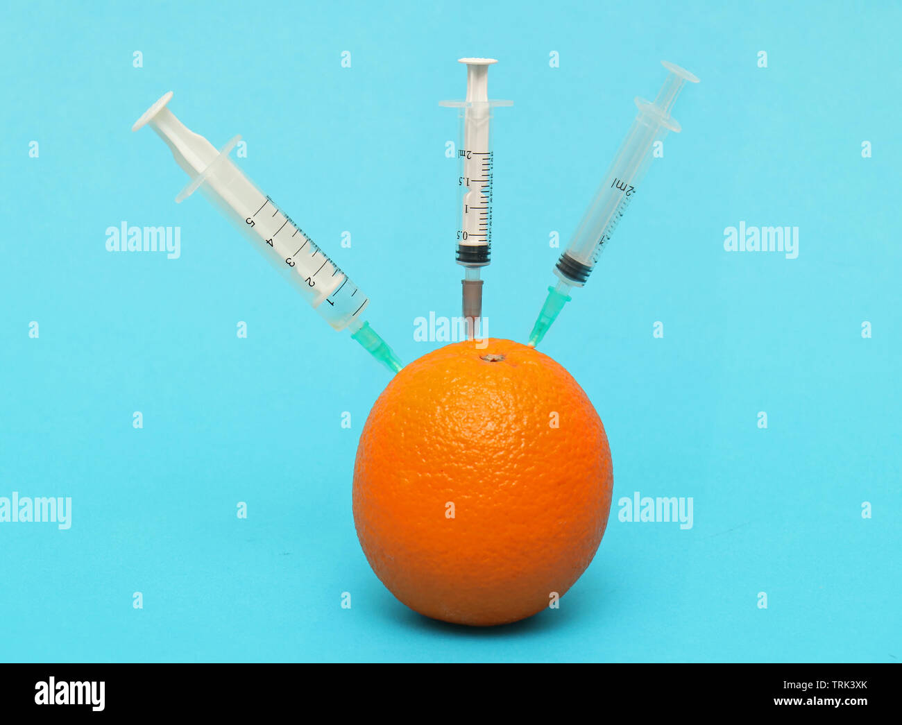 Needles injected inside orange peel as concept for medical treatment ...