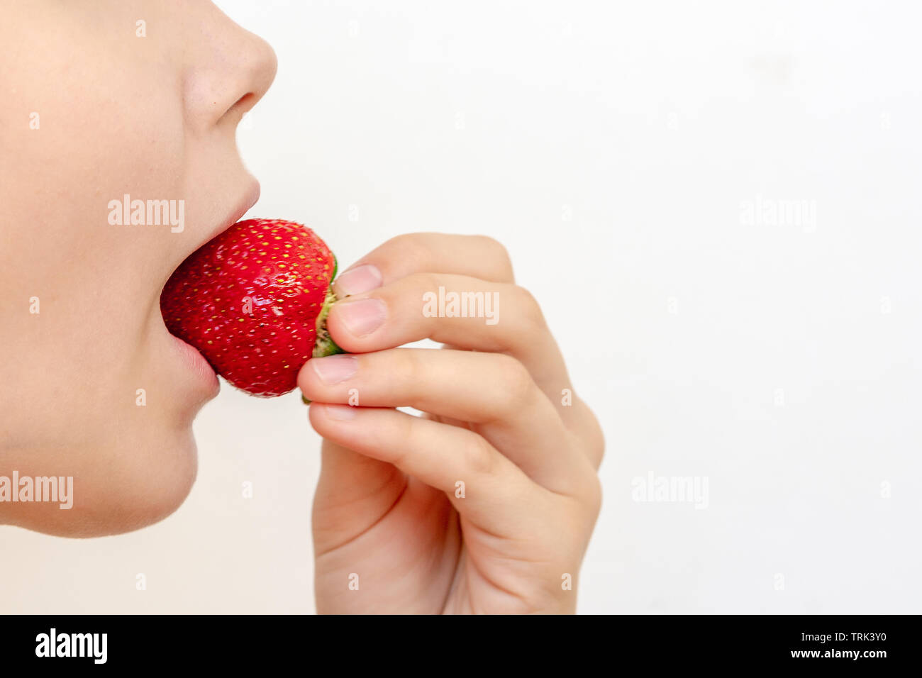 Portrait of yaung woman eating strawberries. Healthy happy smiling ...