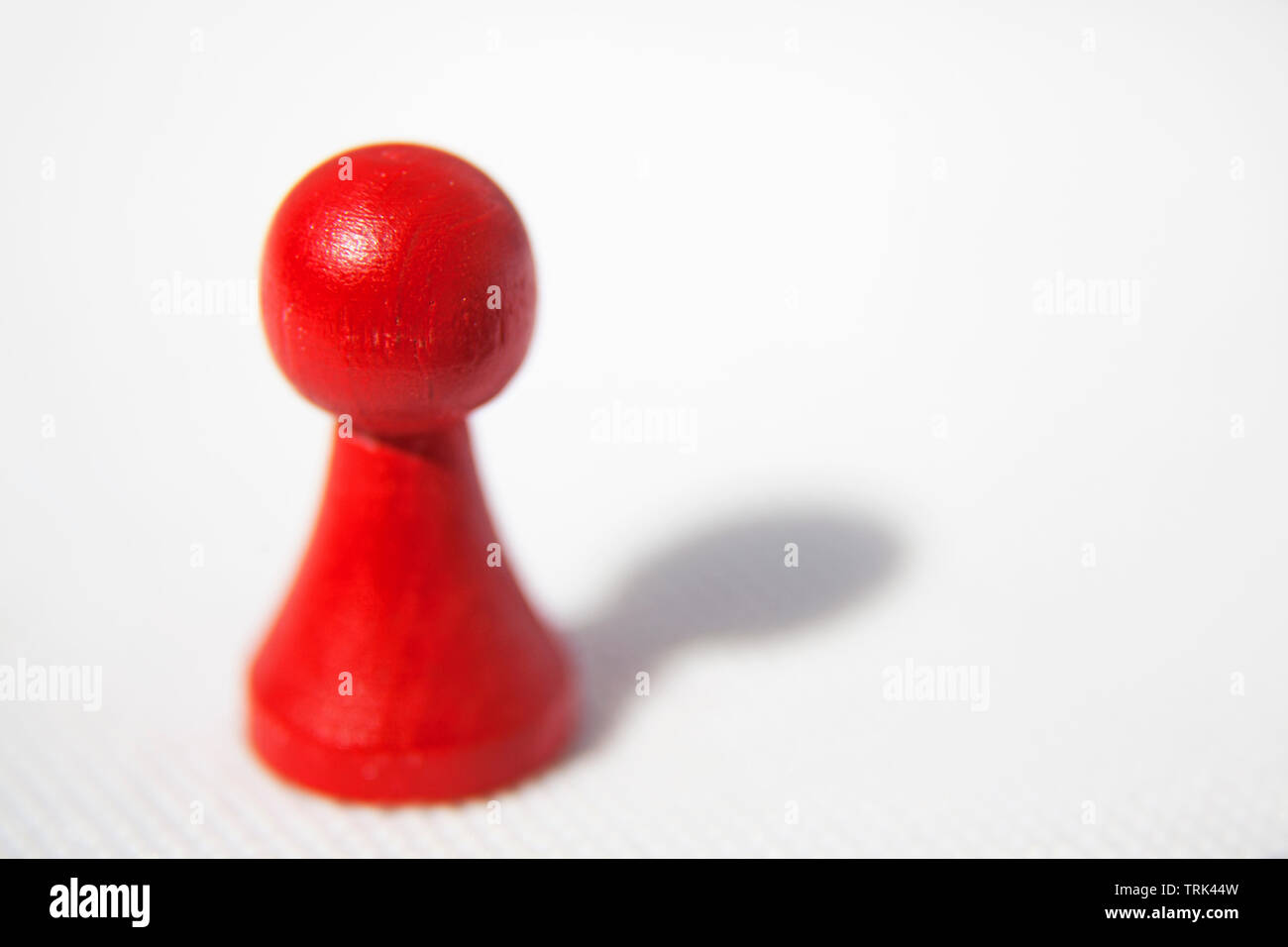 a red game piece on white background Stock Photo - Alamy