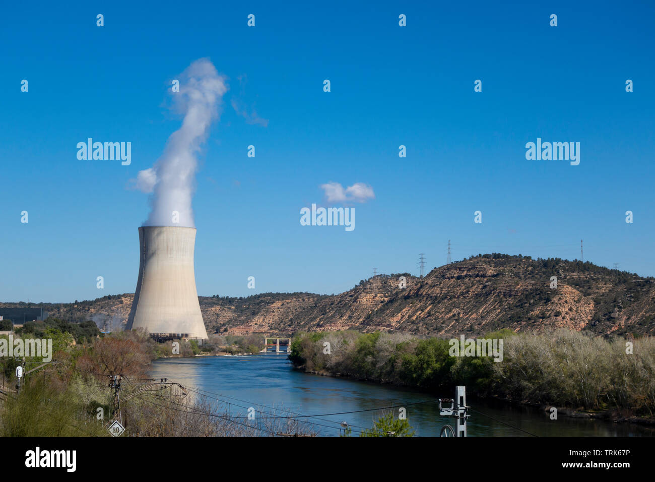Steam chimney in a power nuclear plant, next to the river Stock Photo ...