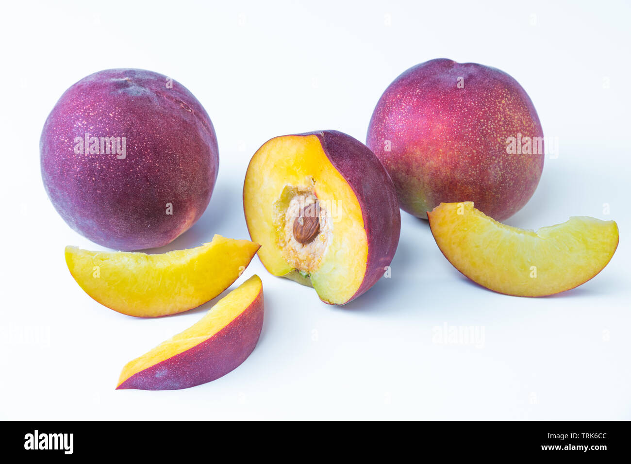 Two nectarines and one sliced nectarines isolated on white background ...