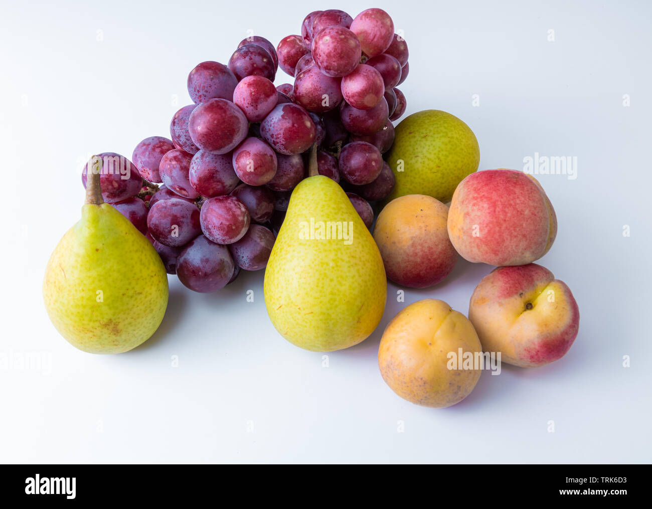 Different fresh fruits. A bunch of grapes, pears, nectarines. soft ...