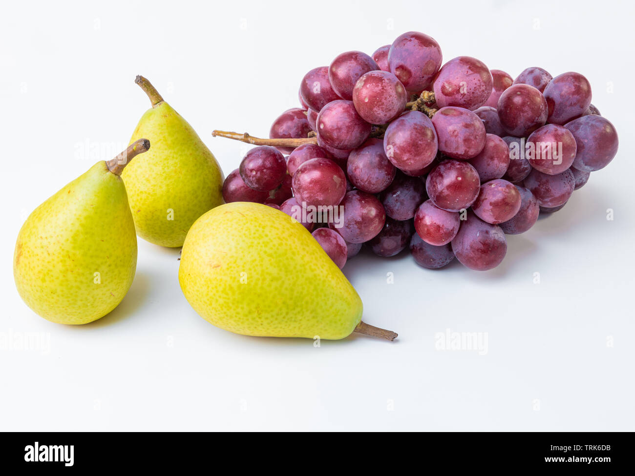 pears and grapes isolated on white background. Contrast of colors ...