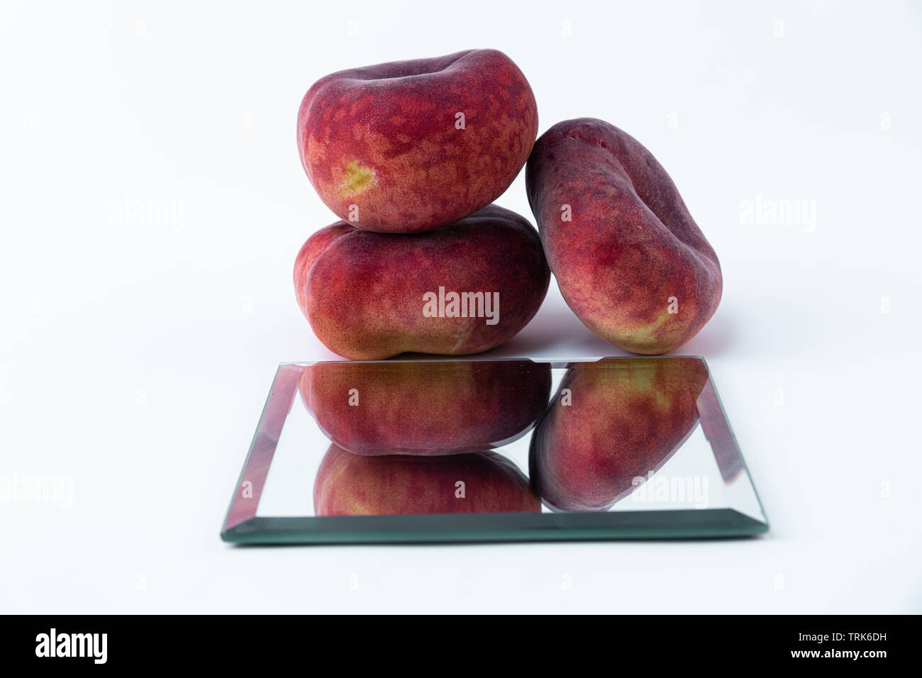 Three paraguayo fruits on white background and a mirror reflection of ...