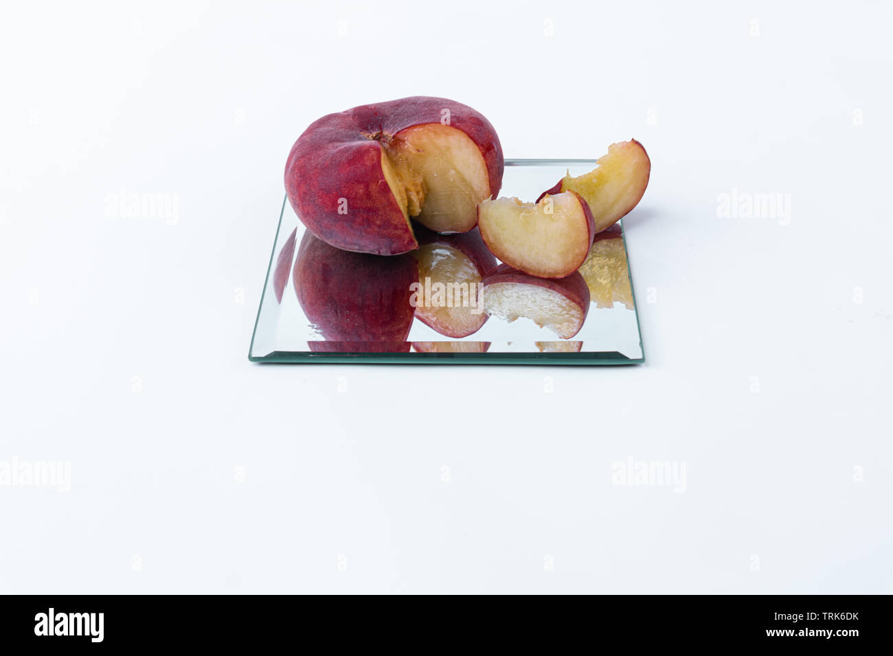 Exotic fruits. A paraguayo sliced on a mirror. White background Stock ...