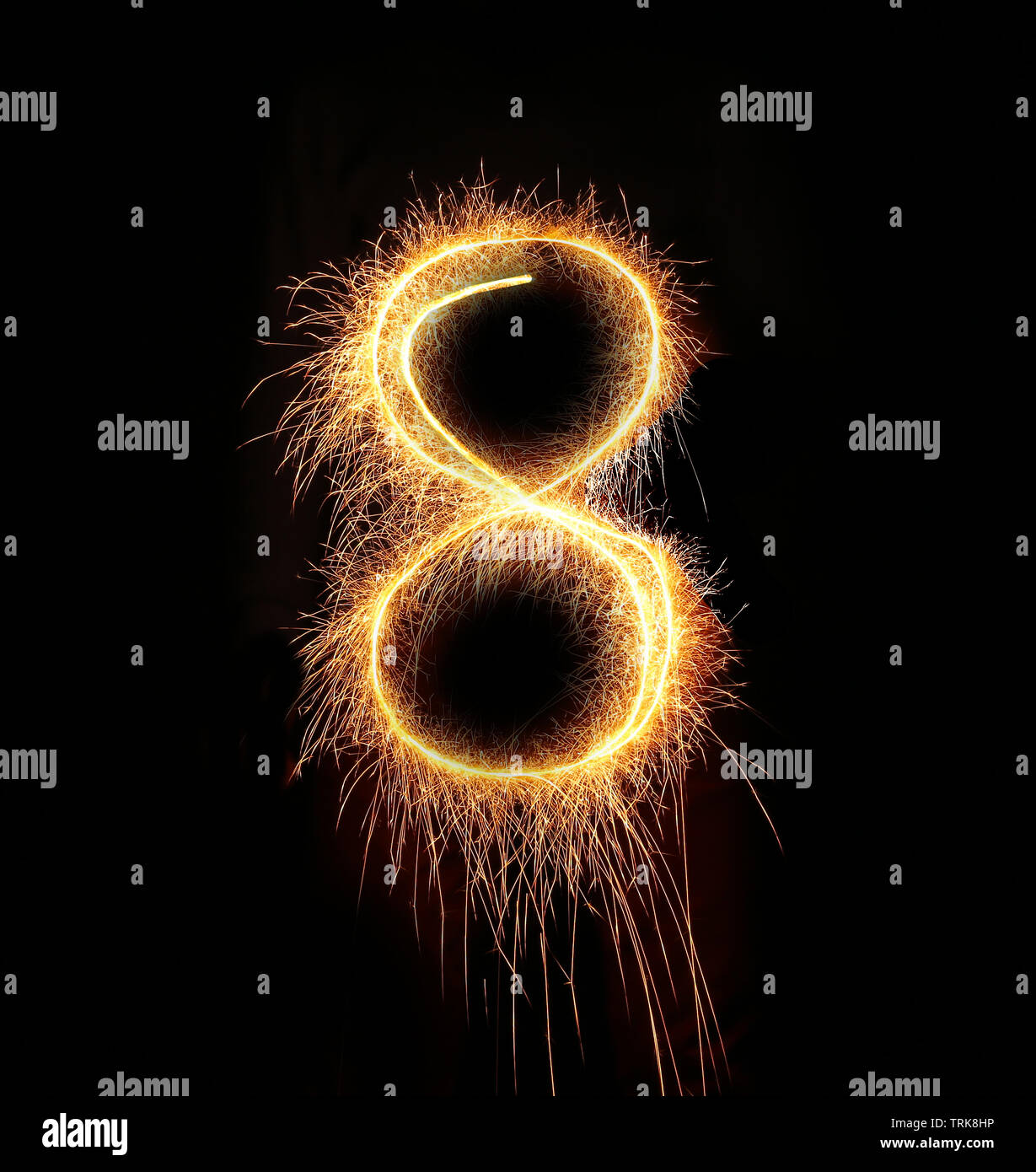 burning sparkler stick and writing sparkling text . number eight ...
