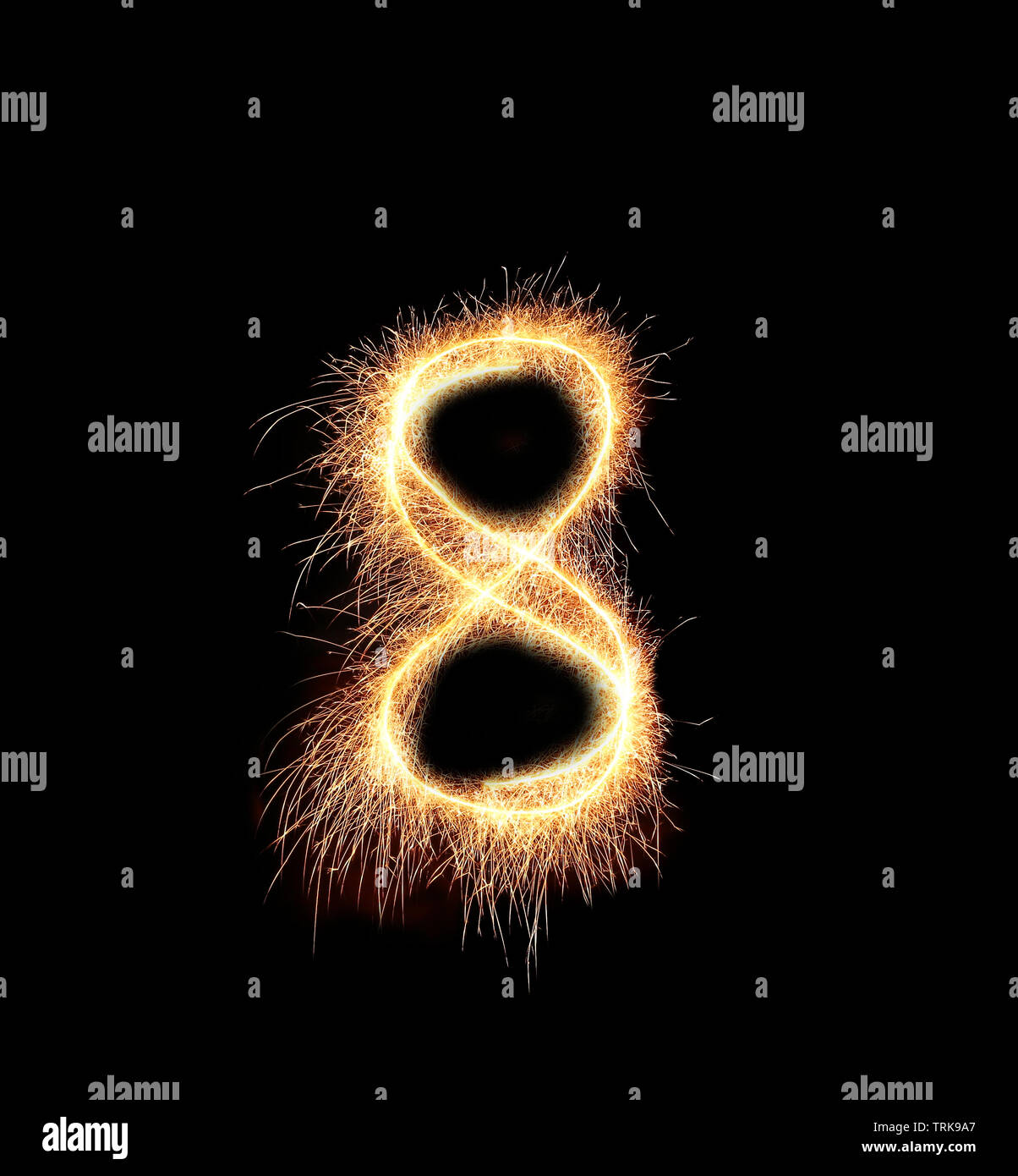 burning sparkler stick and writing sparkling text . number eight ...
