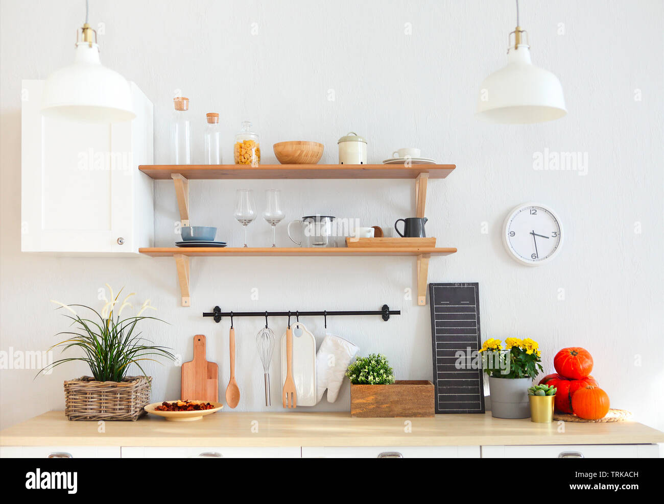 Interior of empty modern white kitchen with various objects on the ...