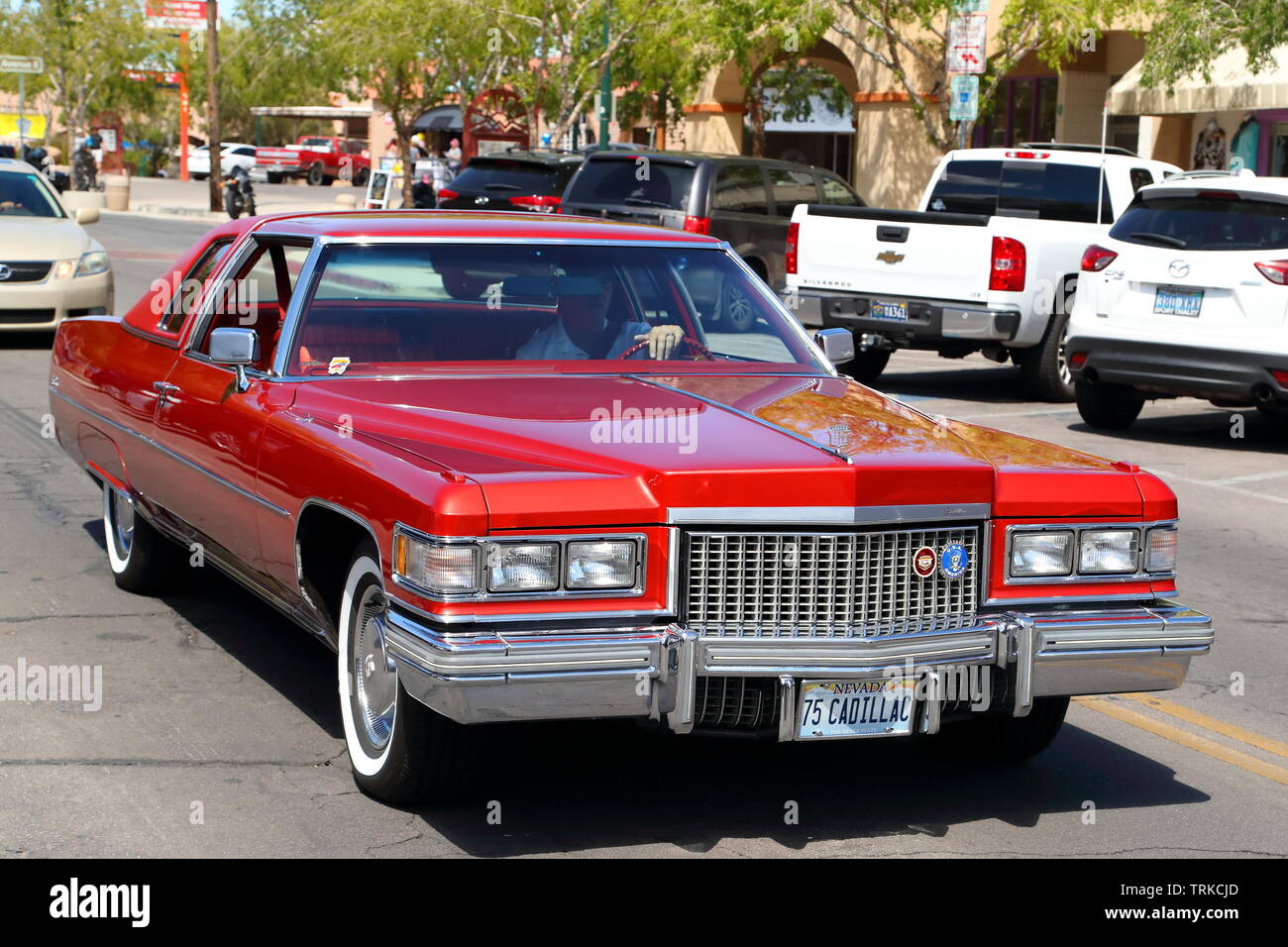 A red Cadillac DeVille amongst vintage vehicles and Hot Rods at a ...