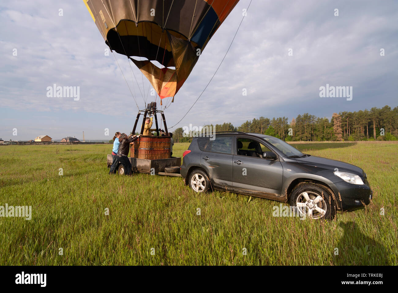 Hot-air balloons getting ready for launching, car and trailer with ...
