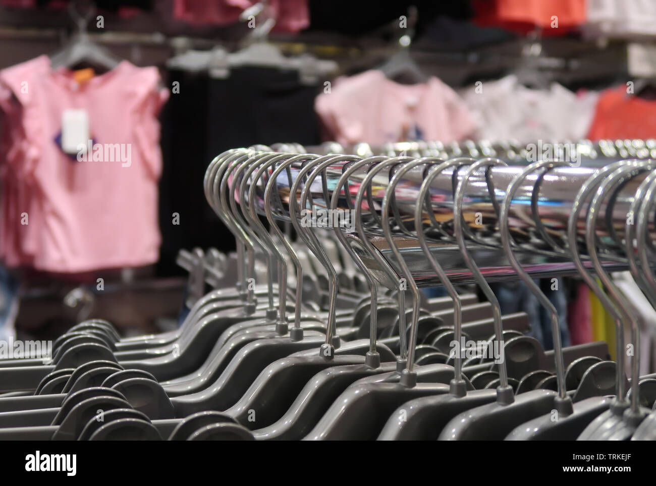 Clothes hanging in a shopping mall Stock Photo - Alamy