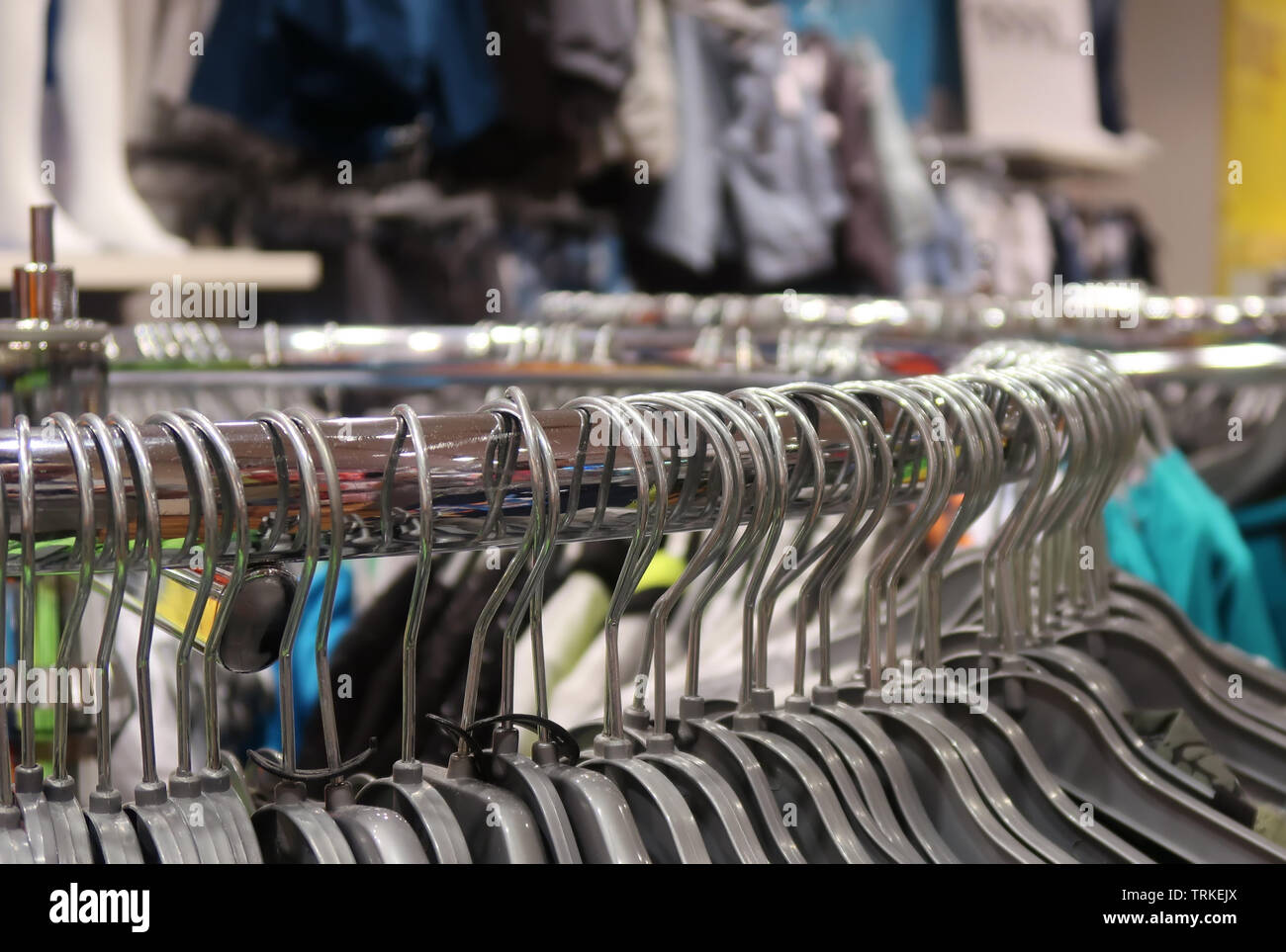 Clothes hanging in a shopping mall Stock Photo - Alamy