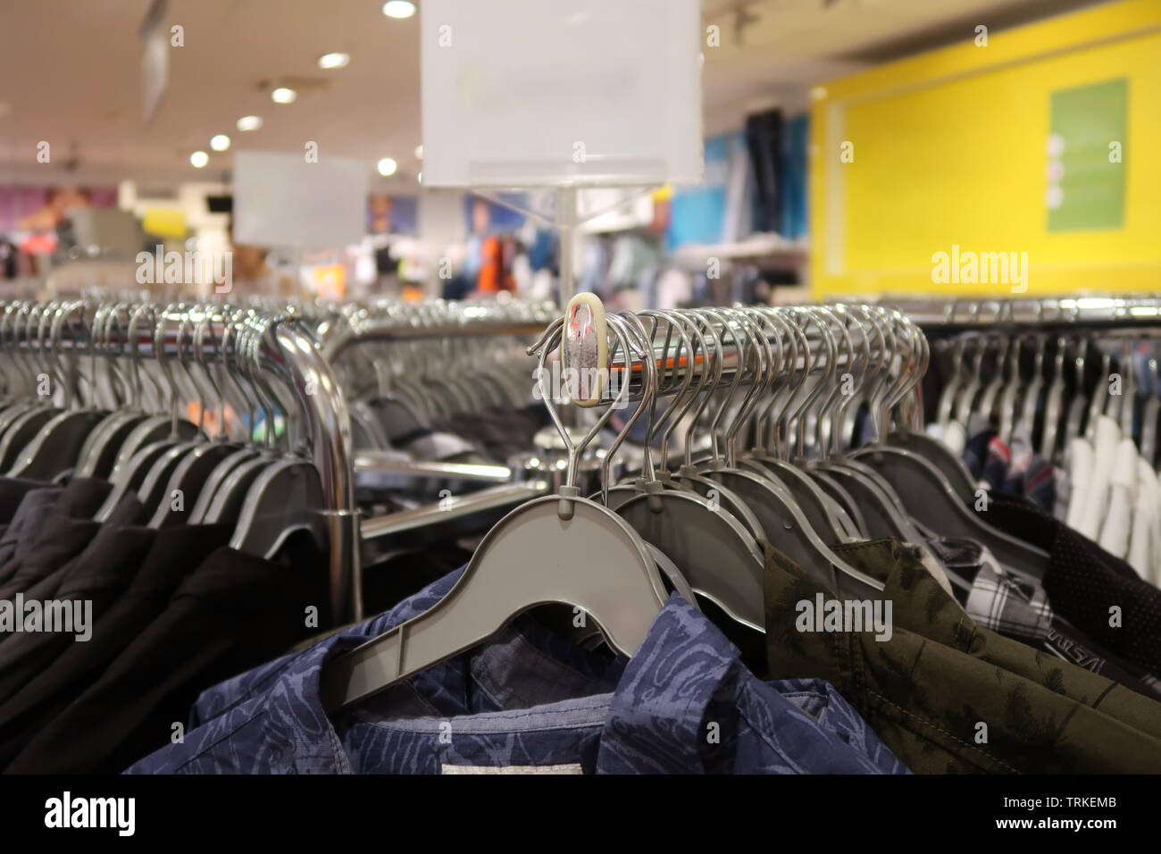 Clothes hanging in a shopping mall Stock Photo - Alamy