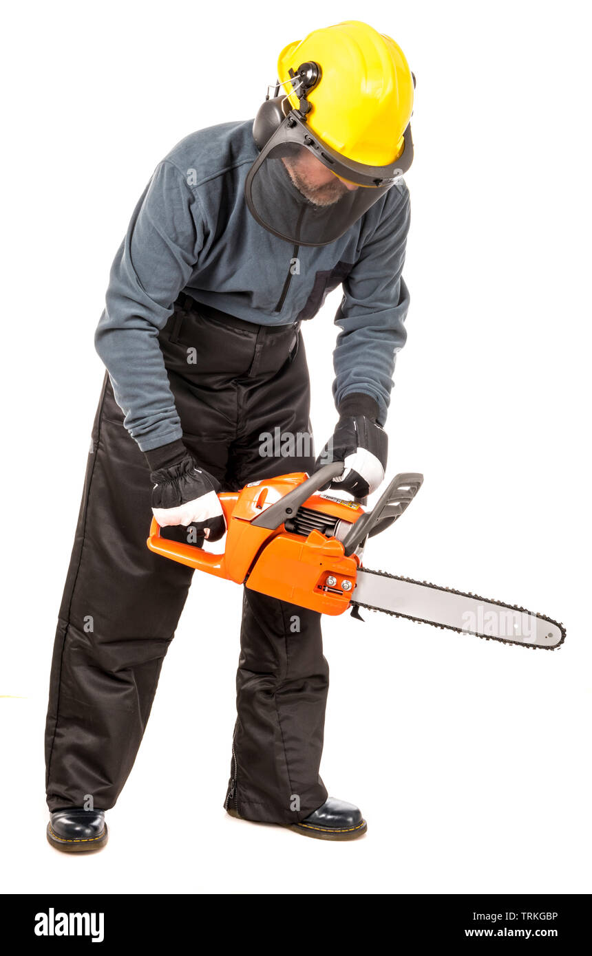 Man in safety gear demonstrating how to hold a chainsaw safely Stock ...