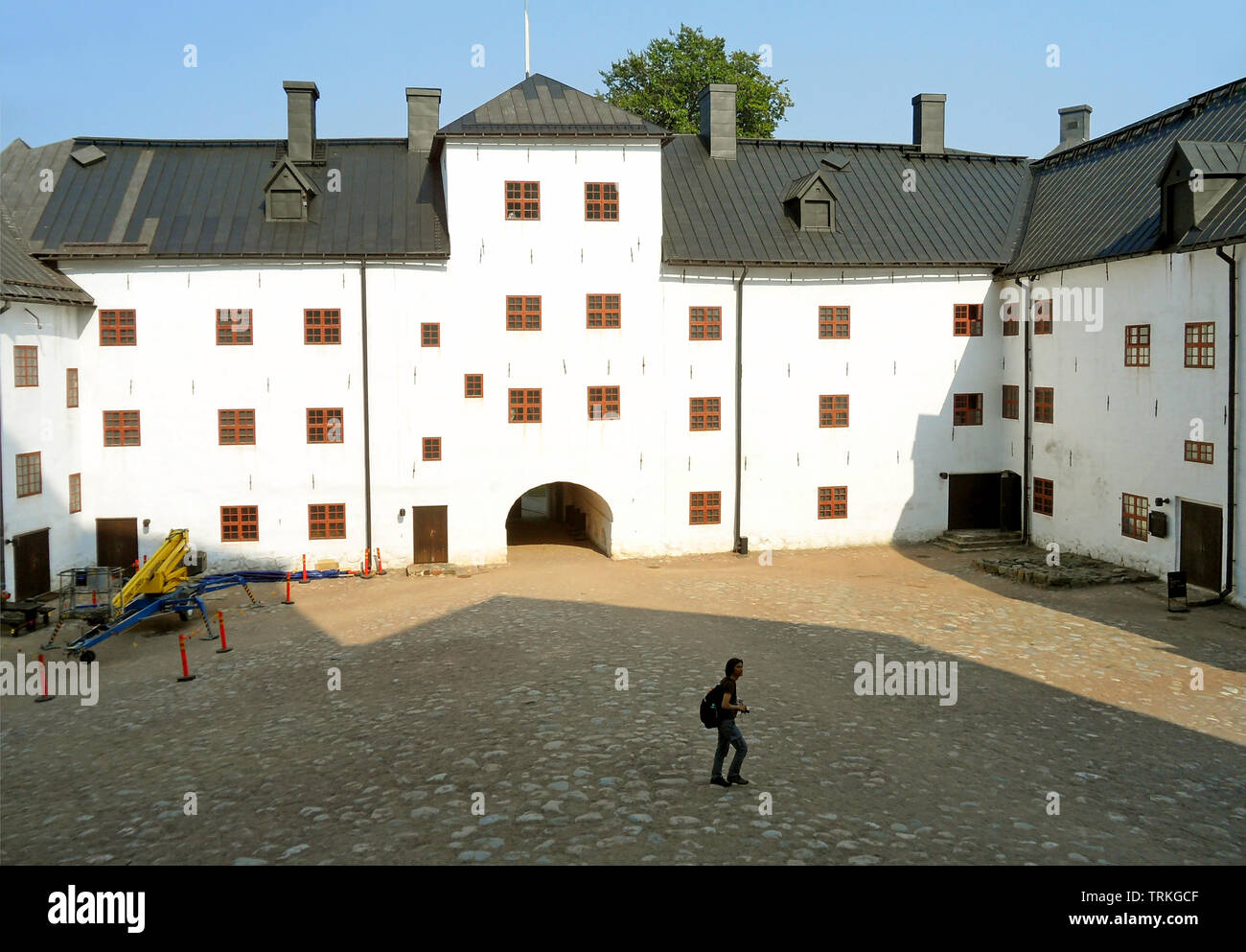 Visitor Exploring the Courtyard of Turku Castle, Historic place in ...