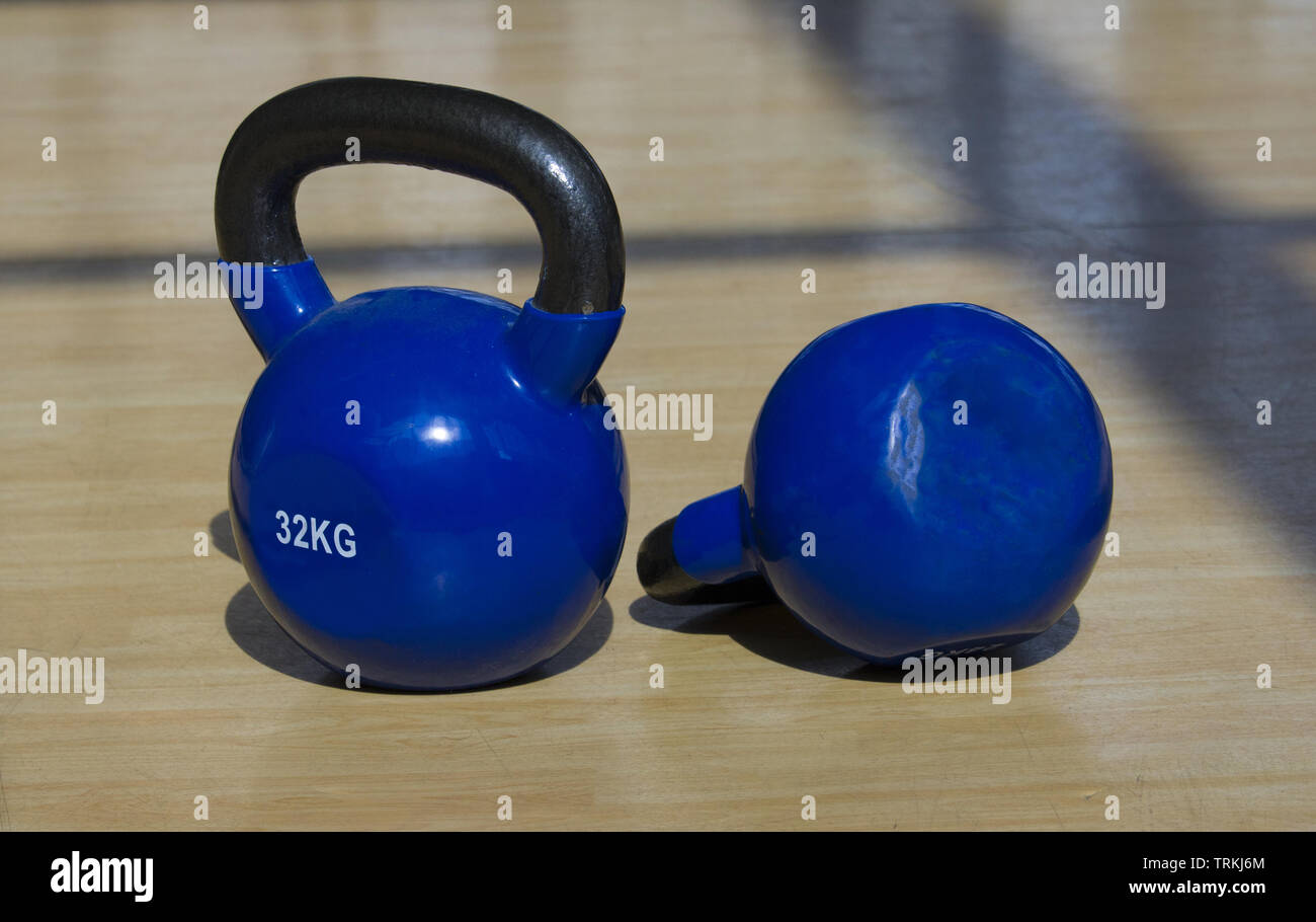 Blue weights for sport. On a floor of gym Stock Photo - Alamy