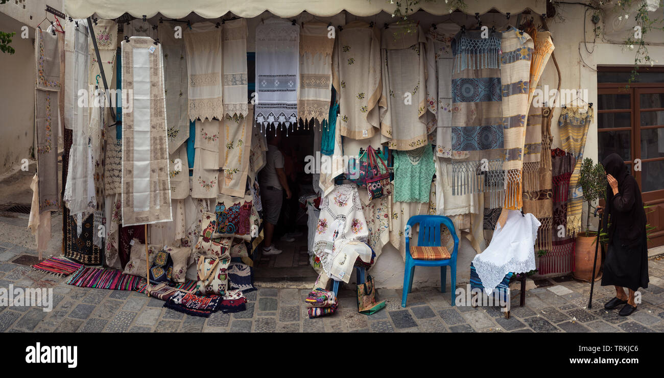 Greek old woman in traditional black dress and Cretan folk crafts ...