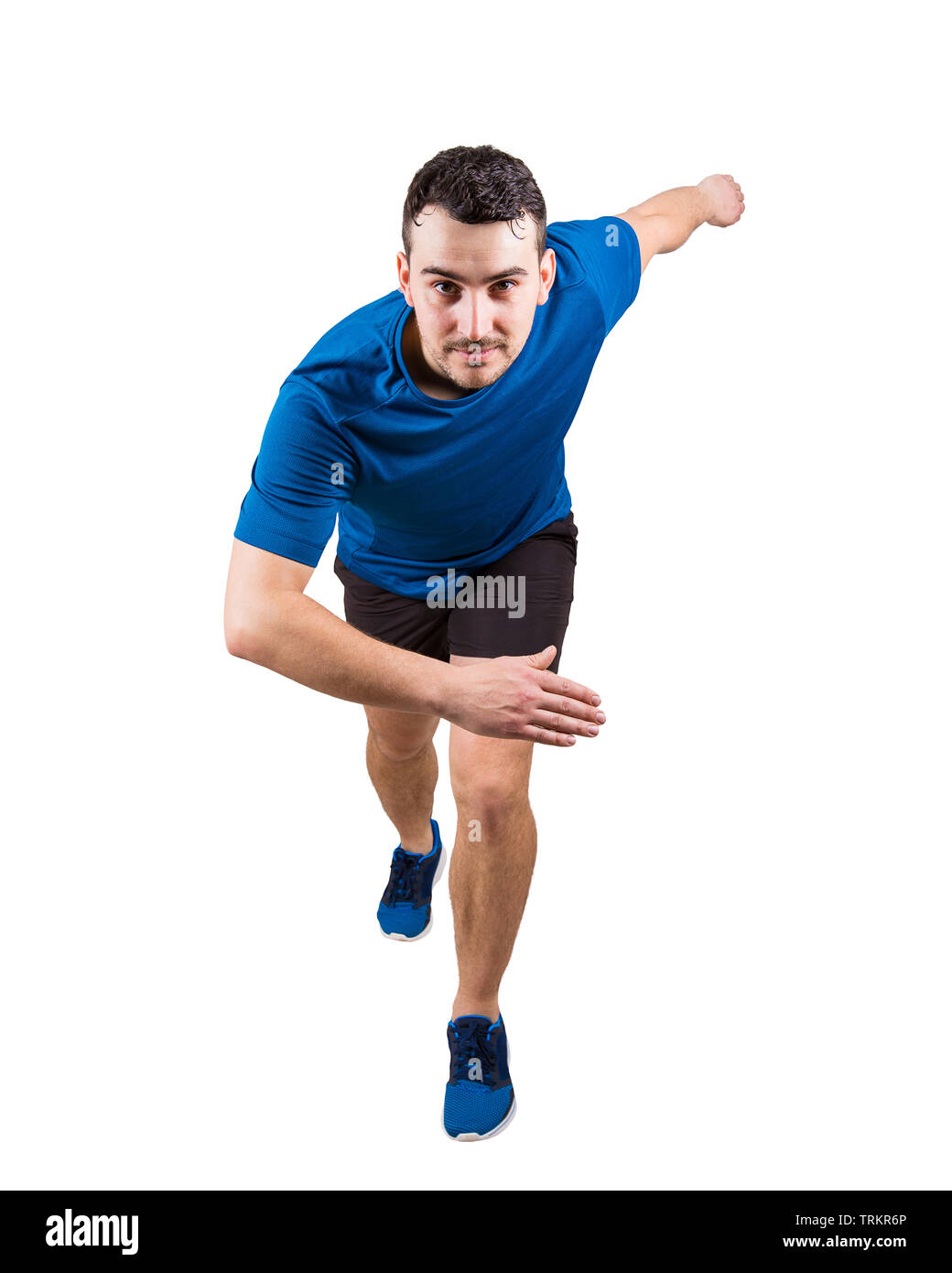 Determined caucasian man runner standing in running position looking ...