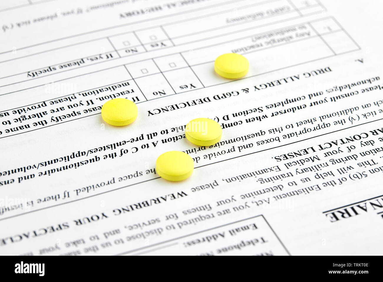 Macro photo of yellow pills on medical questionnaire form Stock Photo ...