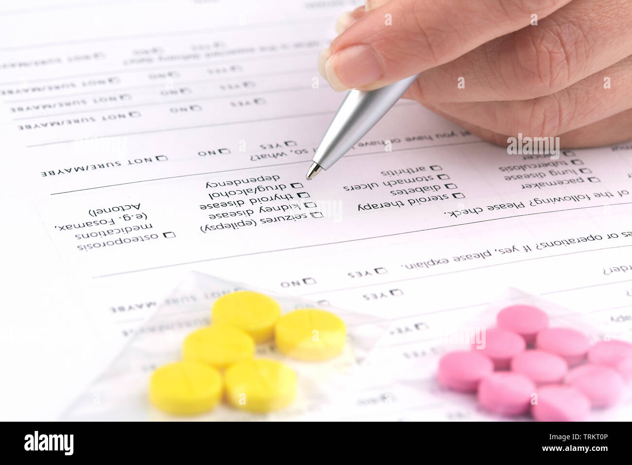 Colorful pills and hand writing on medical questionnaire form Stock ...