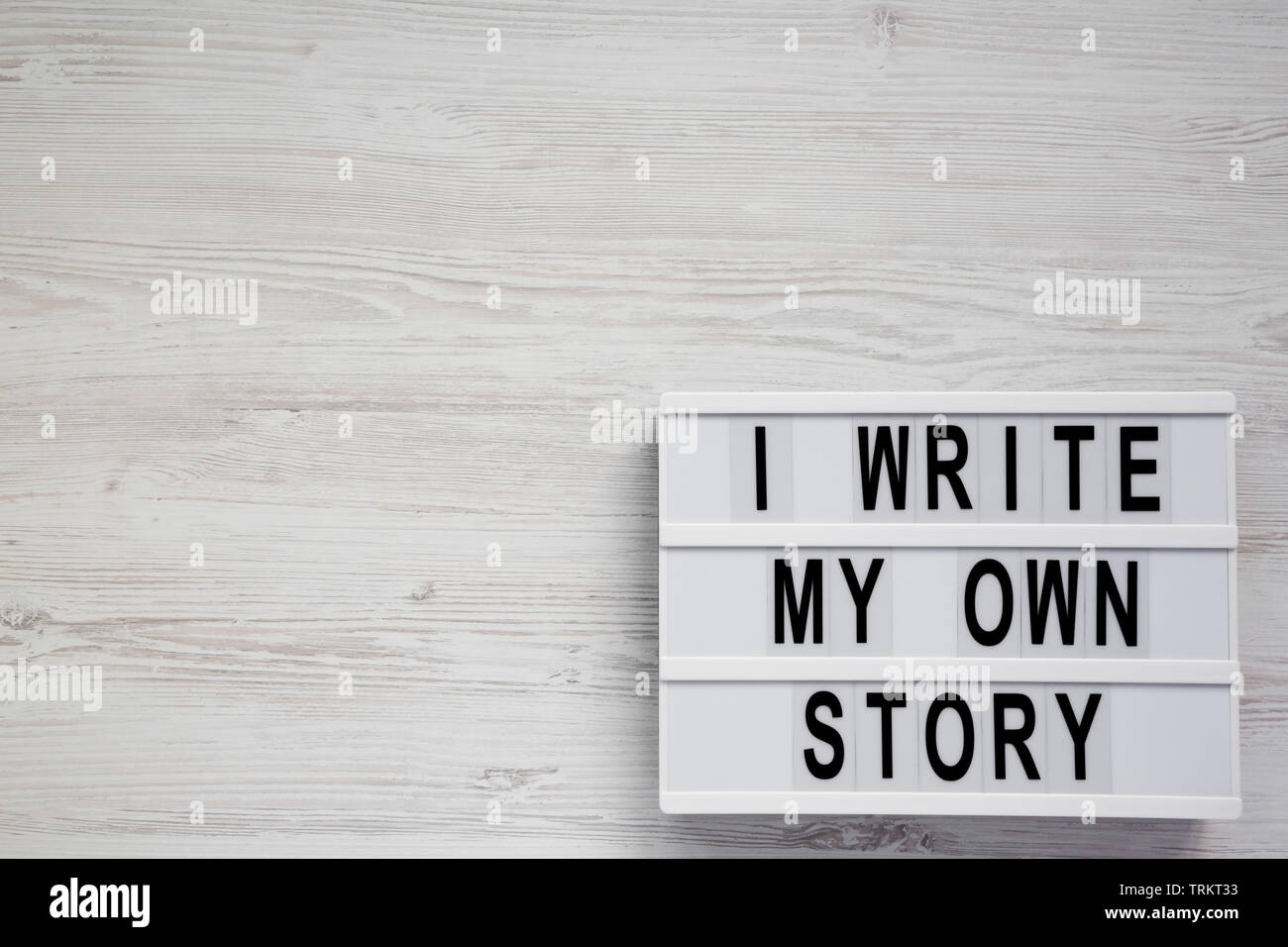 Top view, 'I write my own story' words on a modern board on a white ...