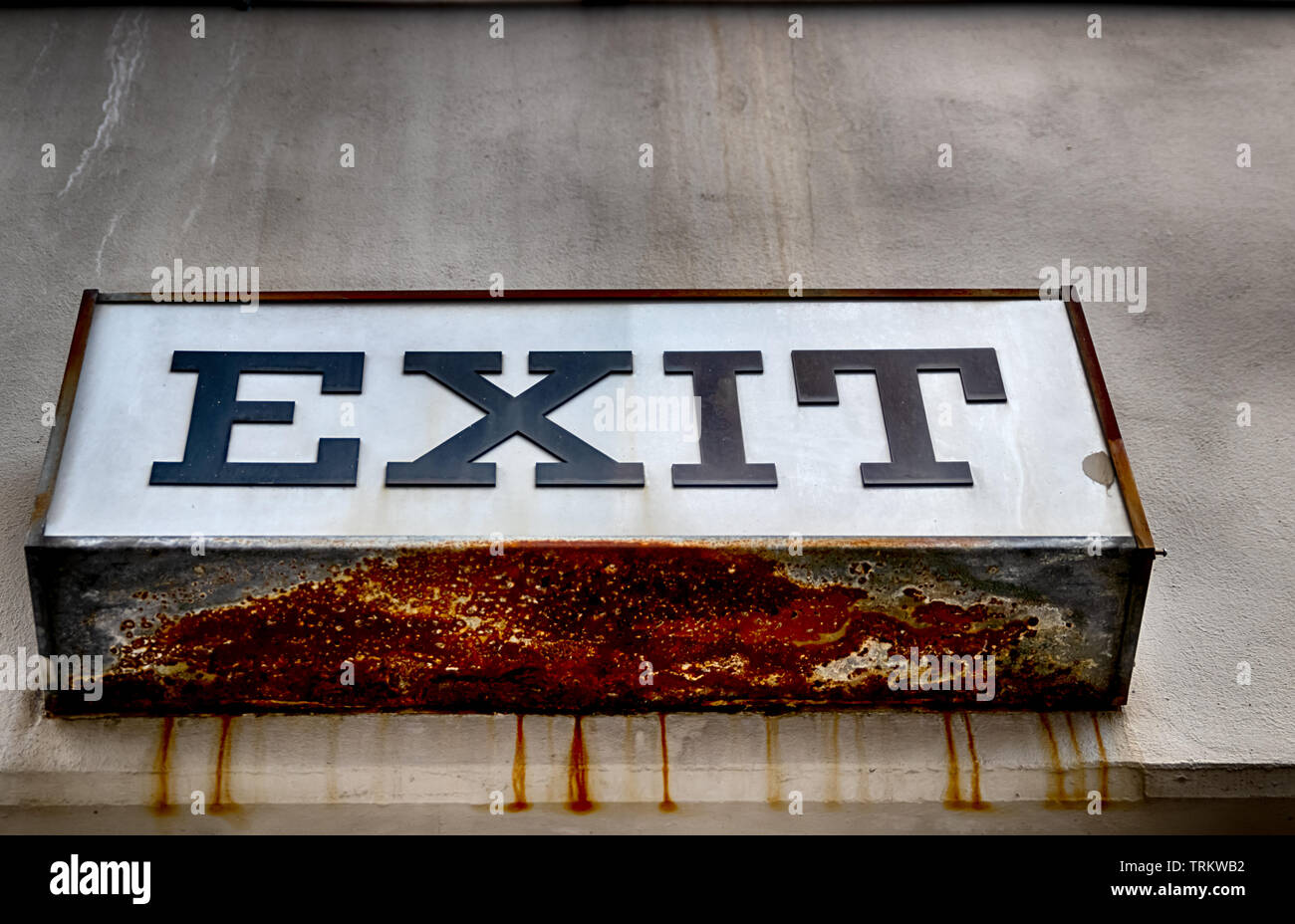 Rusty worn exit sign on a concrete wall in daylight Stock Photo - Alamy