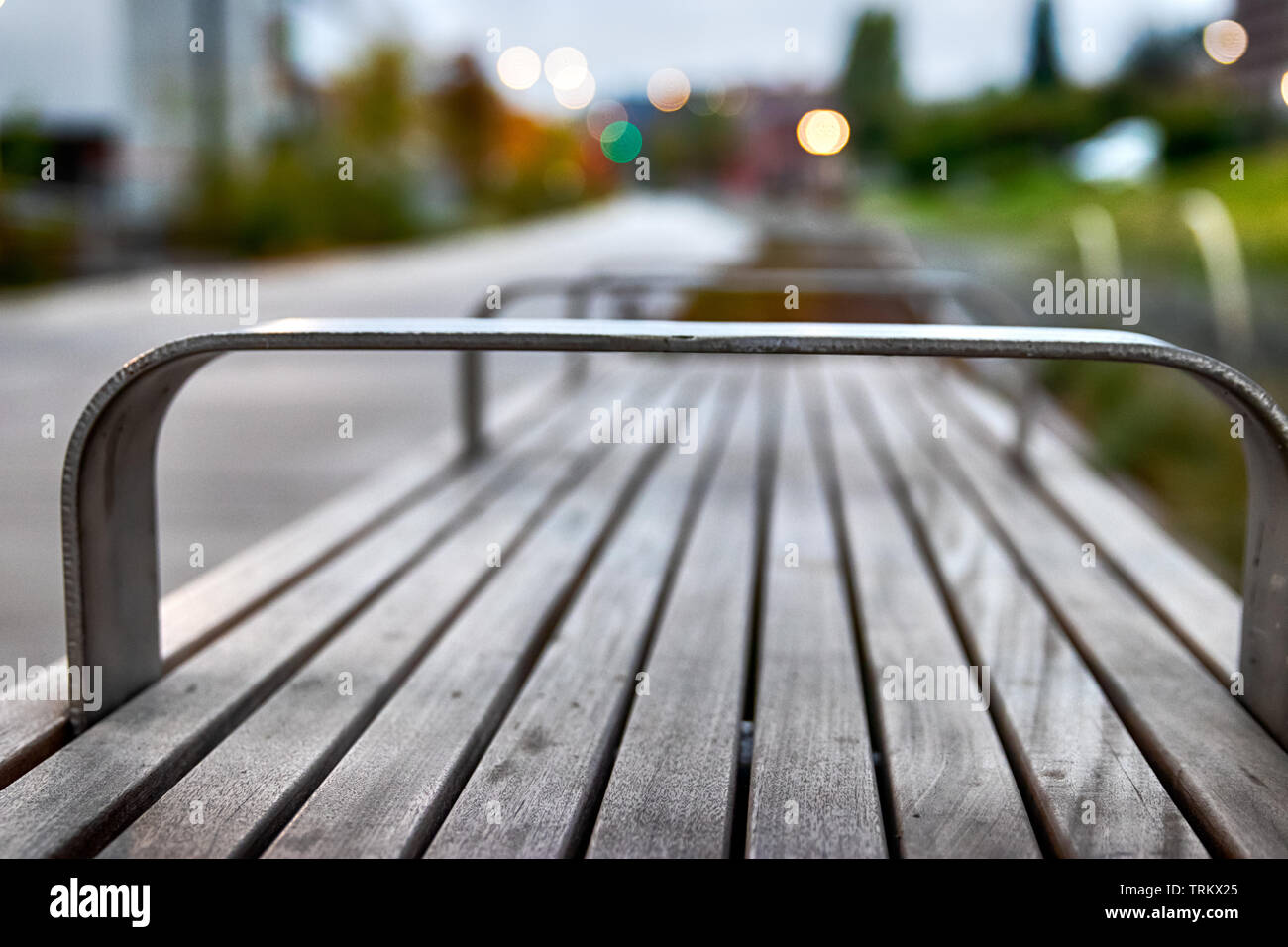 City park bench with buildings and shallow depth of field Stock Photo ...