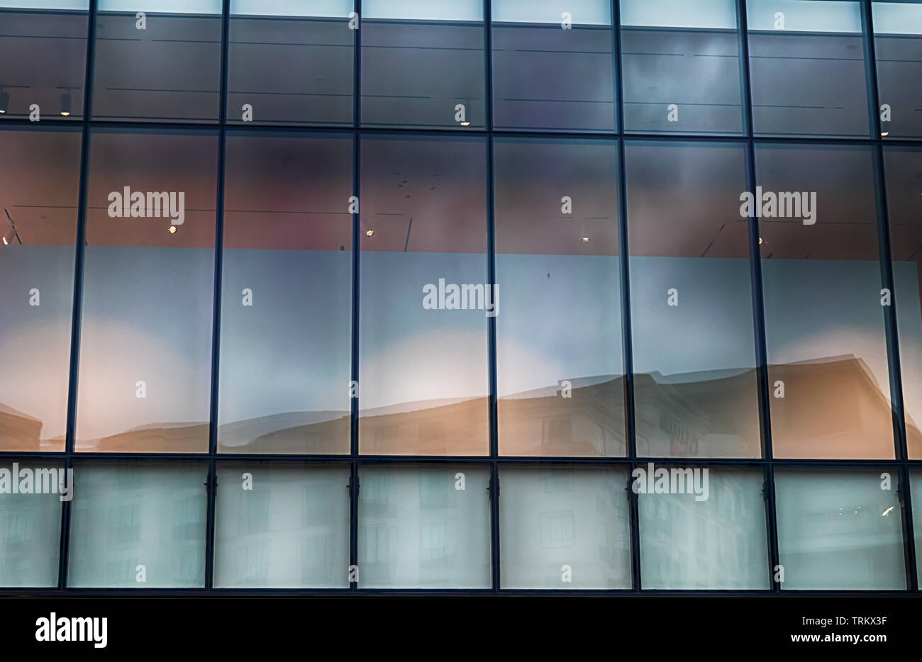 Abstract building window glass with light blue reflections in daylight ...