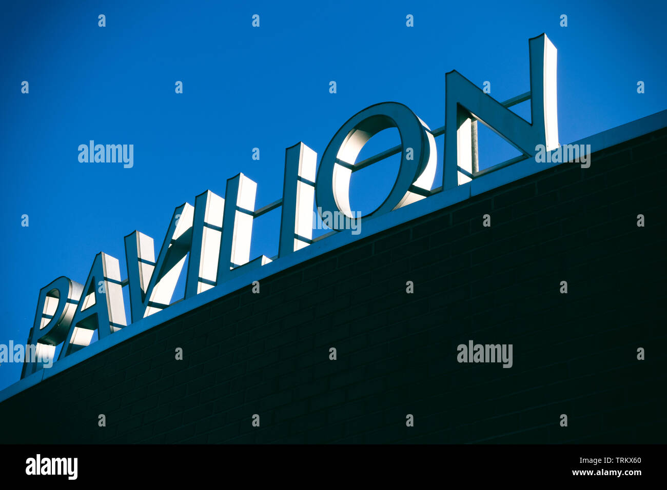 Modern building sigh with words pavilion and blue sky Stock Photo - Alamy