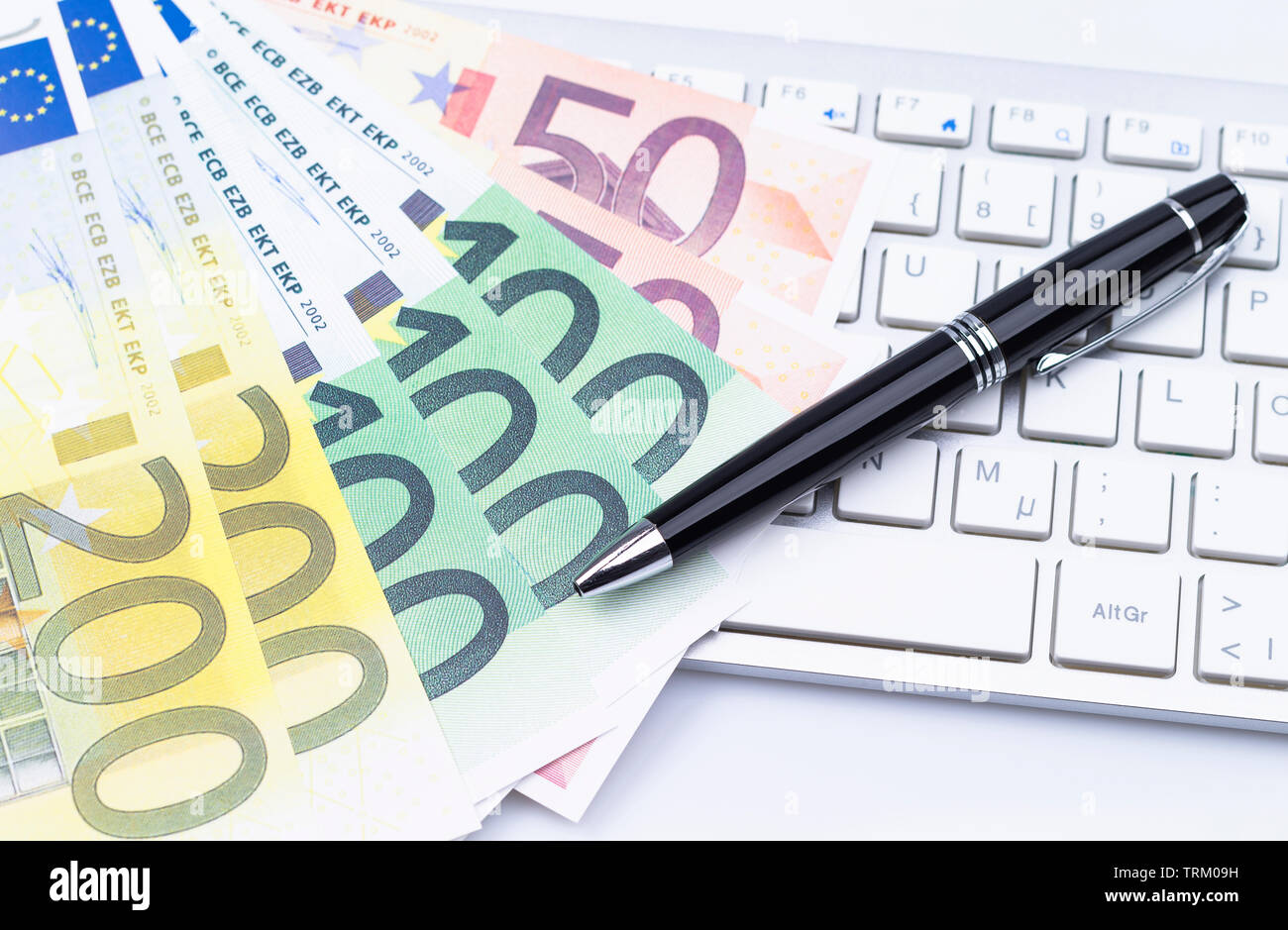 The image shows some banknotes on a keyboard, isolated on white Stock ...