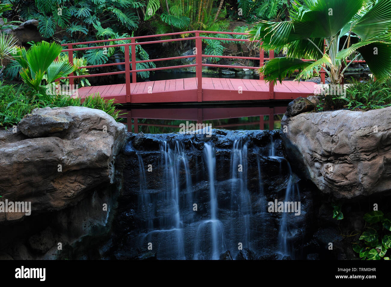 Red wooden bridge over waterfall. Photo credit: © Billy Grimes/Alamy ...