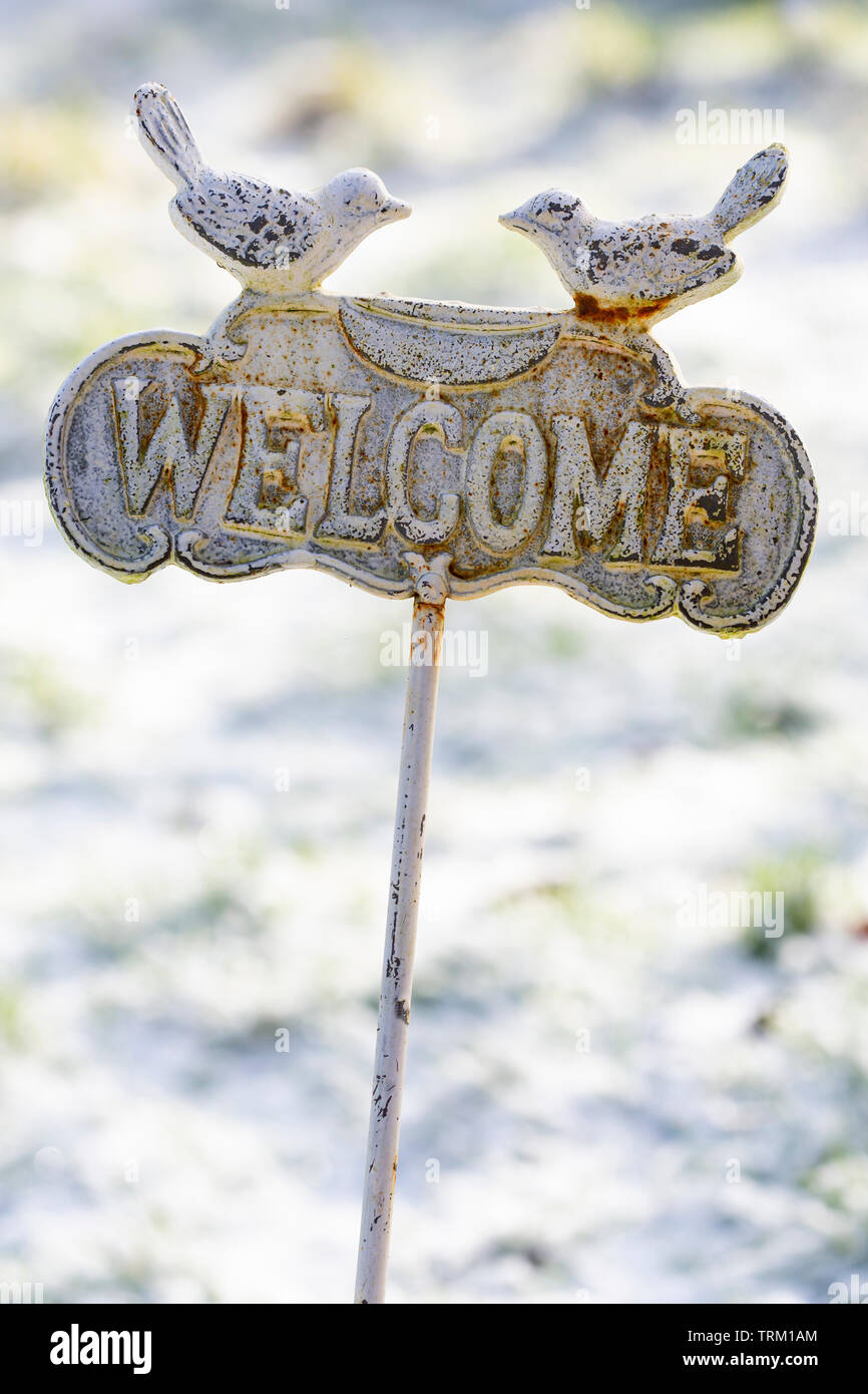 Rusty "welcome" sign in snow Stock Photo - Alamy