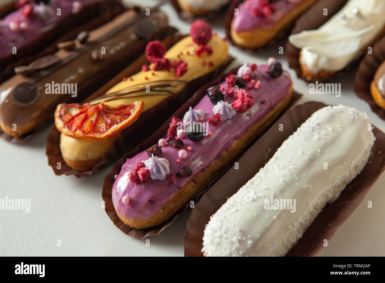 Set of several eclairs with various fillings and design isolate on a ...