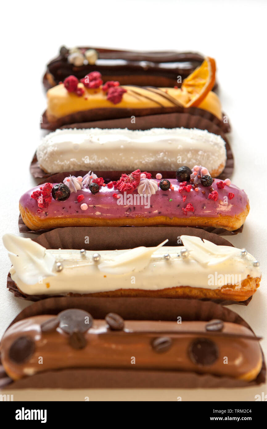 Set of several eclairs with various fillings and design isolate on a ...
