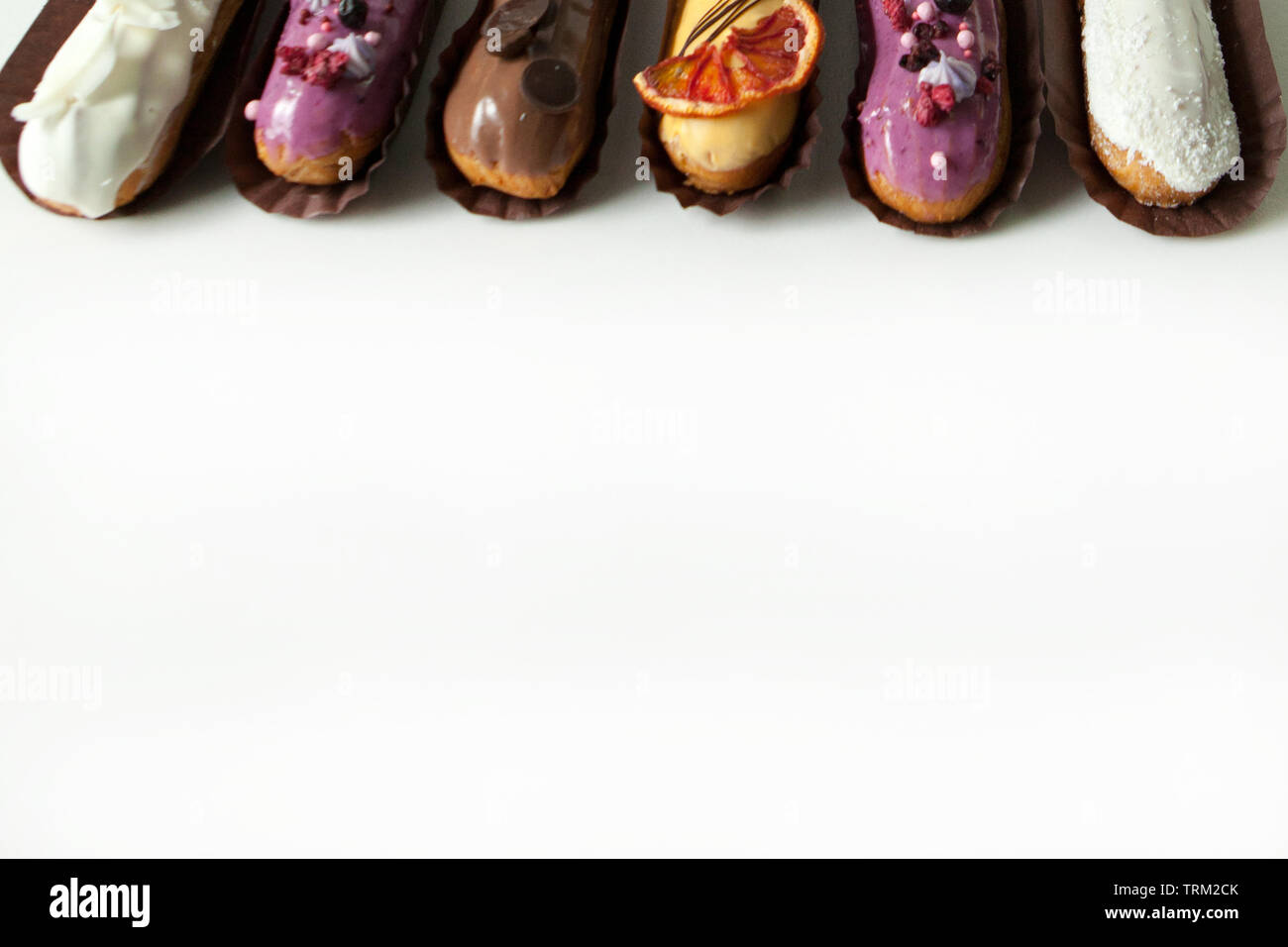 Set of several eclairs with various fillings and design isolate on a ...