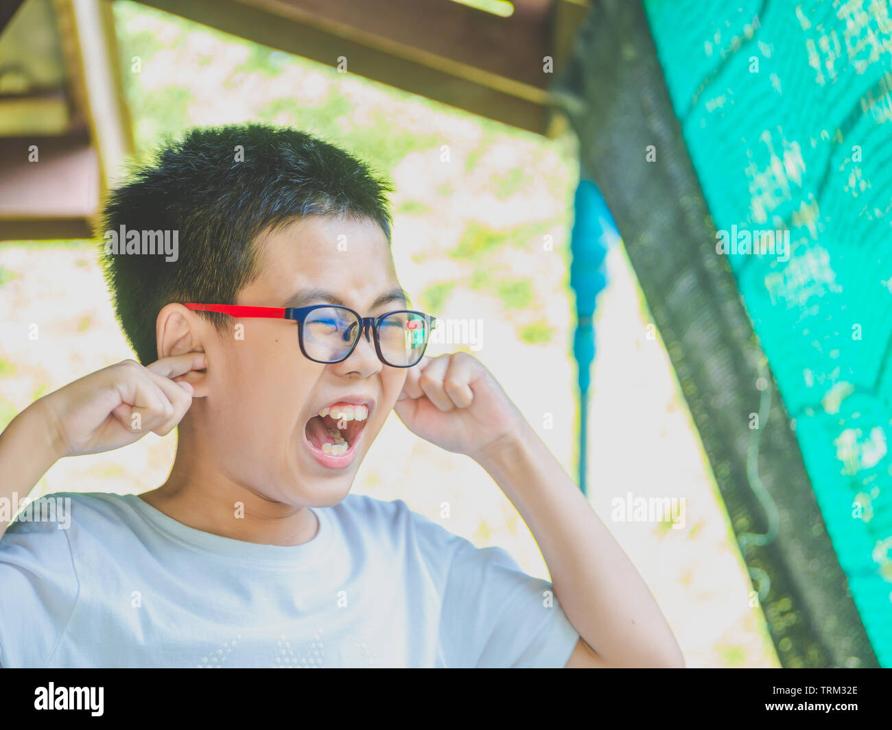 Asia boy in a noisy place from outside Stock Photo - Alamy