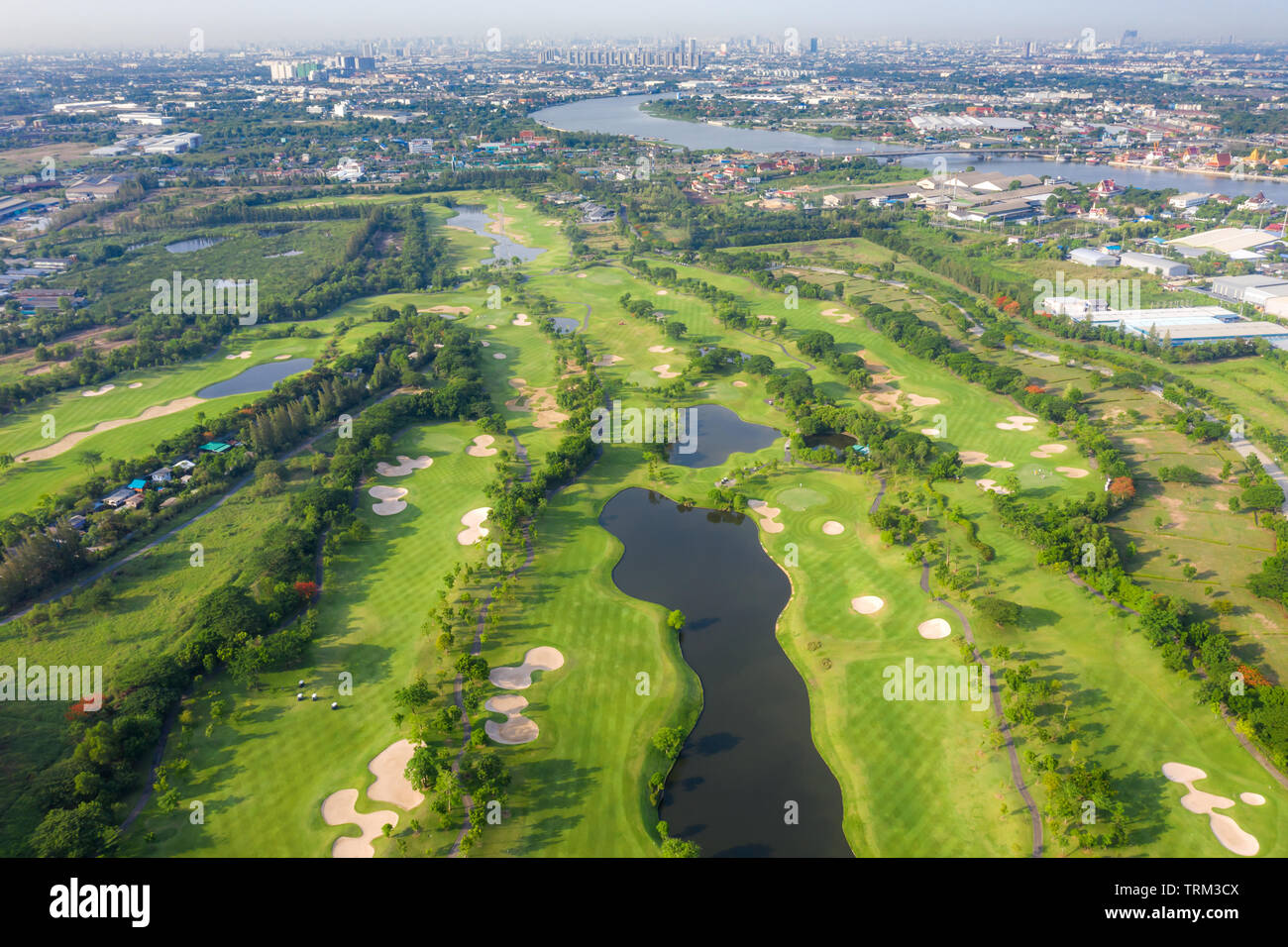Aerial panoramic view of golf course and houses in city Stock Photo - Alamy