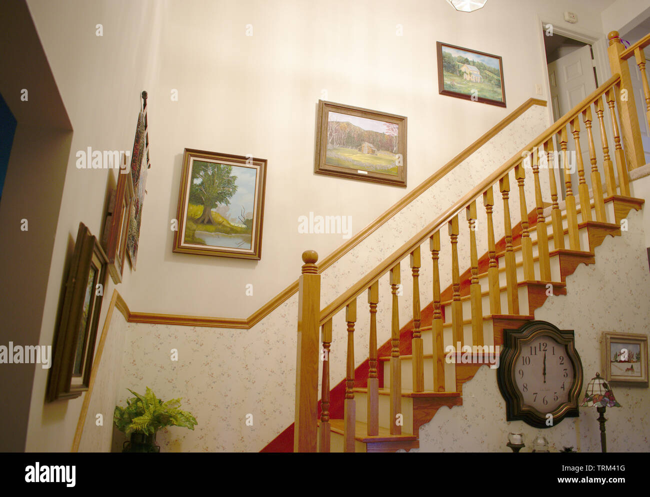 Foyer with paintings and stairs Stock Photo - Alamy